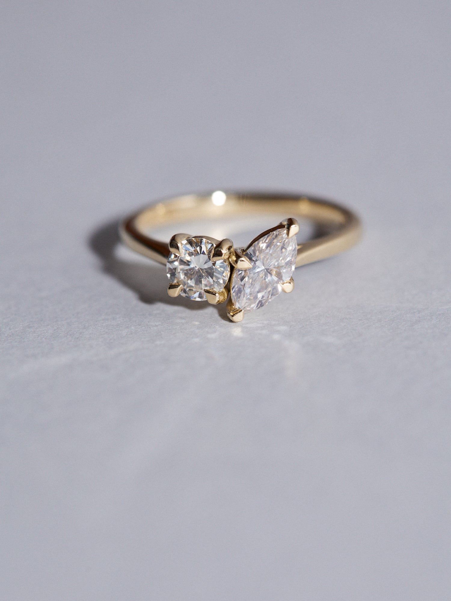 0.50ct Marquise and 0.40ct round cut diamond cathedral engagement ring